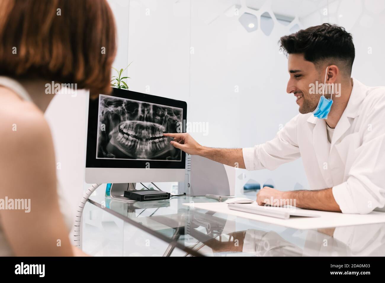 Female dentist showing x ray to patient at medical clinic hi-res stock ...
