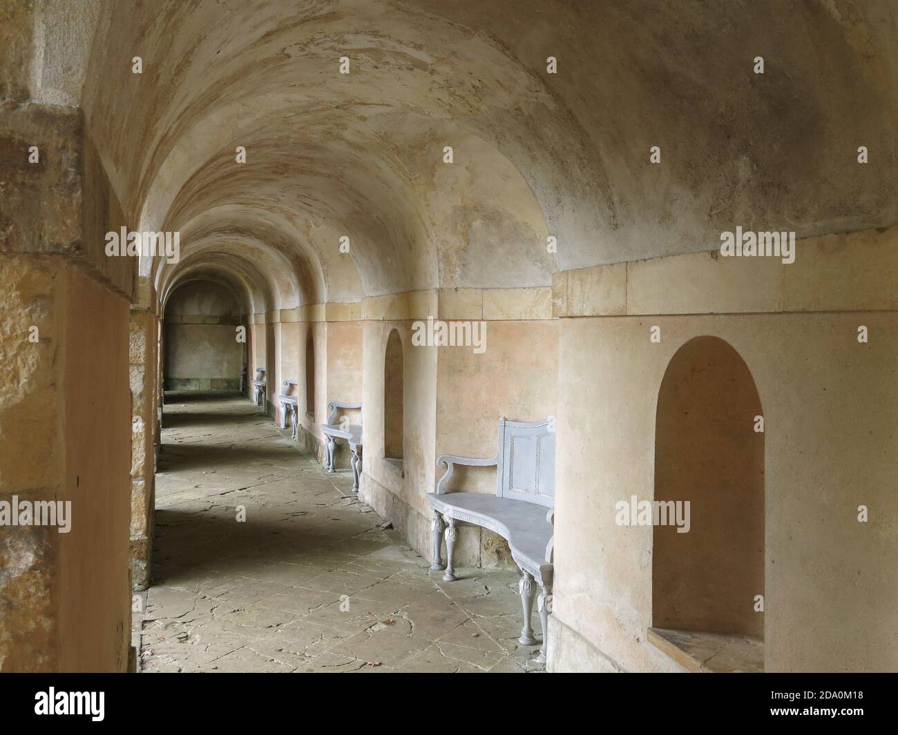 The arched arcade with seating in alcoves along its length; a feature ...