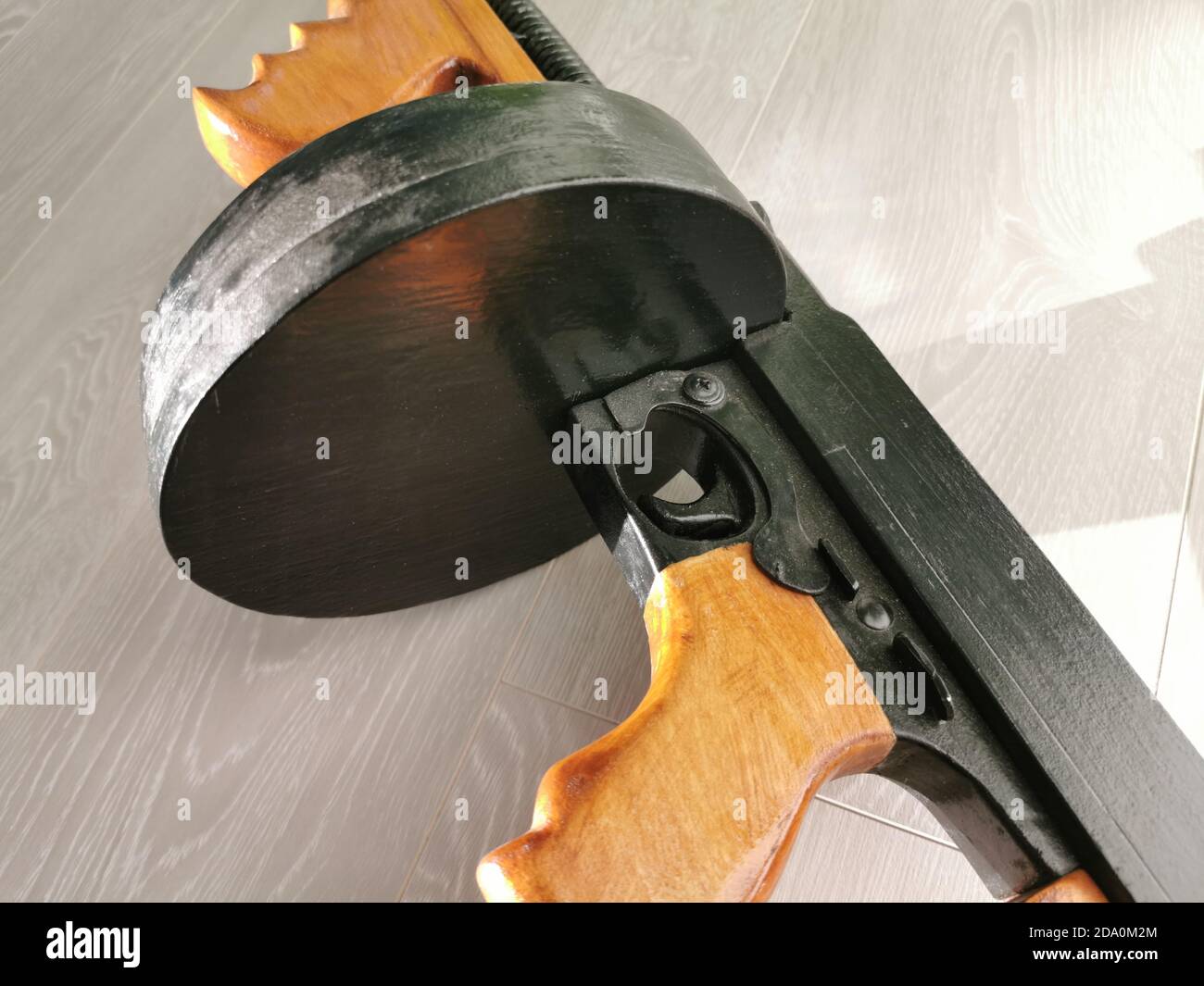 Hanged wooden thompson machine gun and automatic rifle toys at counter ...