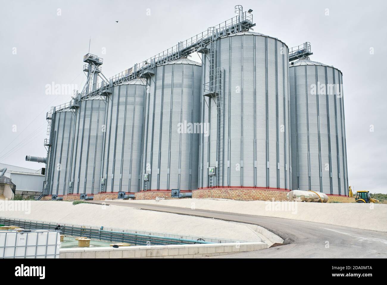 Low angle of huge steel agricultural silo towers located at factory ...