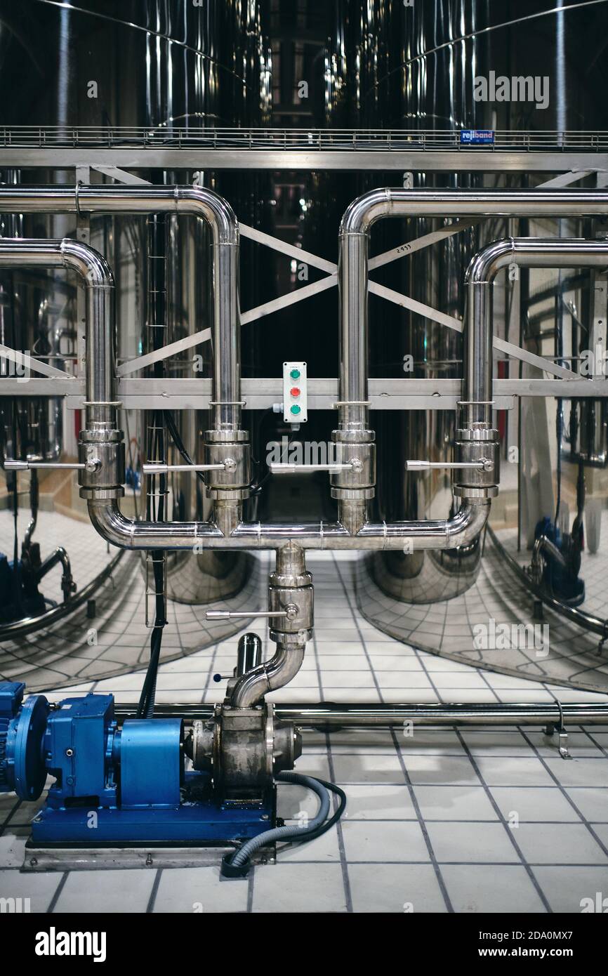 Metal pipes with control panel with buttons connected to steel tanks ...