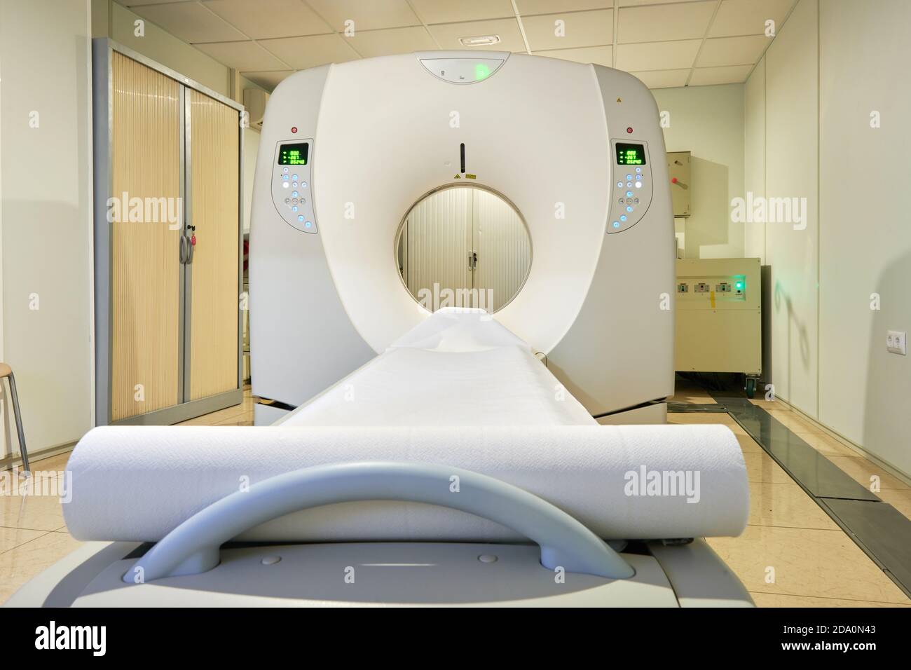 Contemporary computerized tomography scan machine with couch and gantry ...