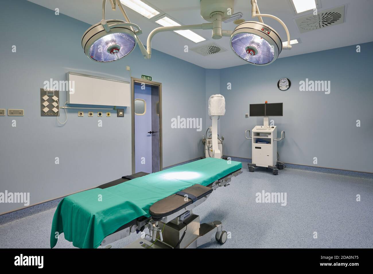 Contemporary operating room interior with couch under shiny lamps near ...