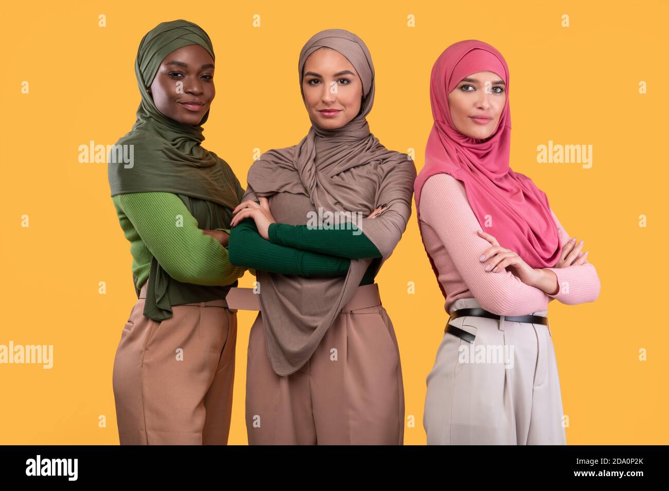 Three Diverse Muslim Ladies In Hijab Standing Together, Yellow ...