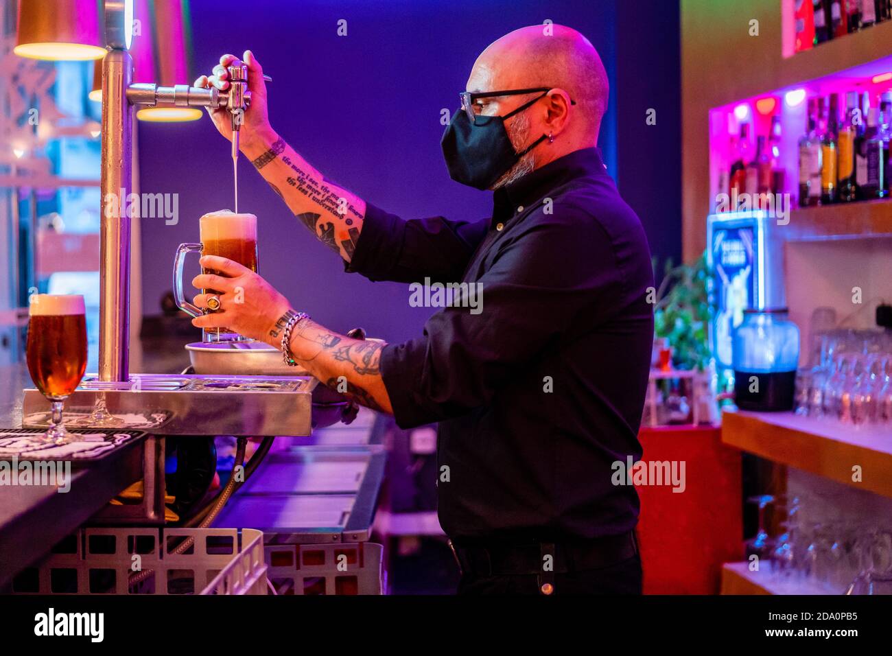 Black female singer performing song against microphone with pop filter ...