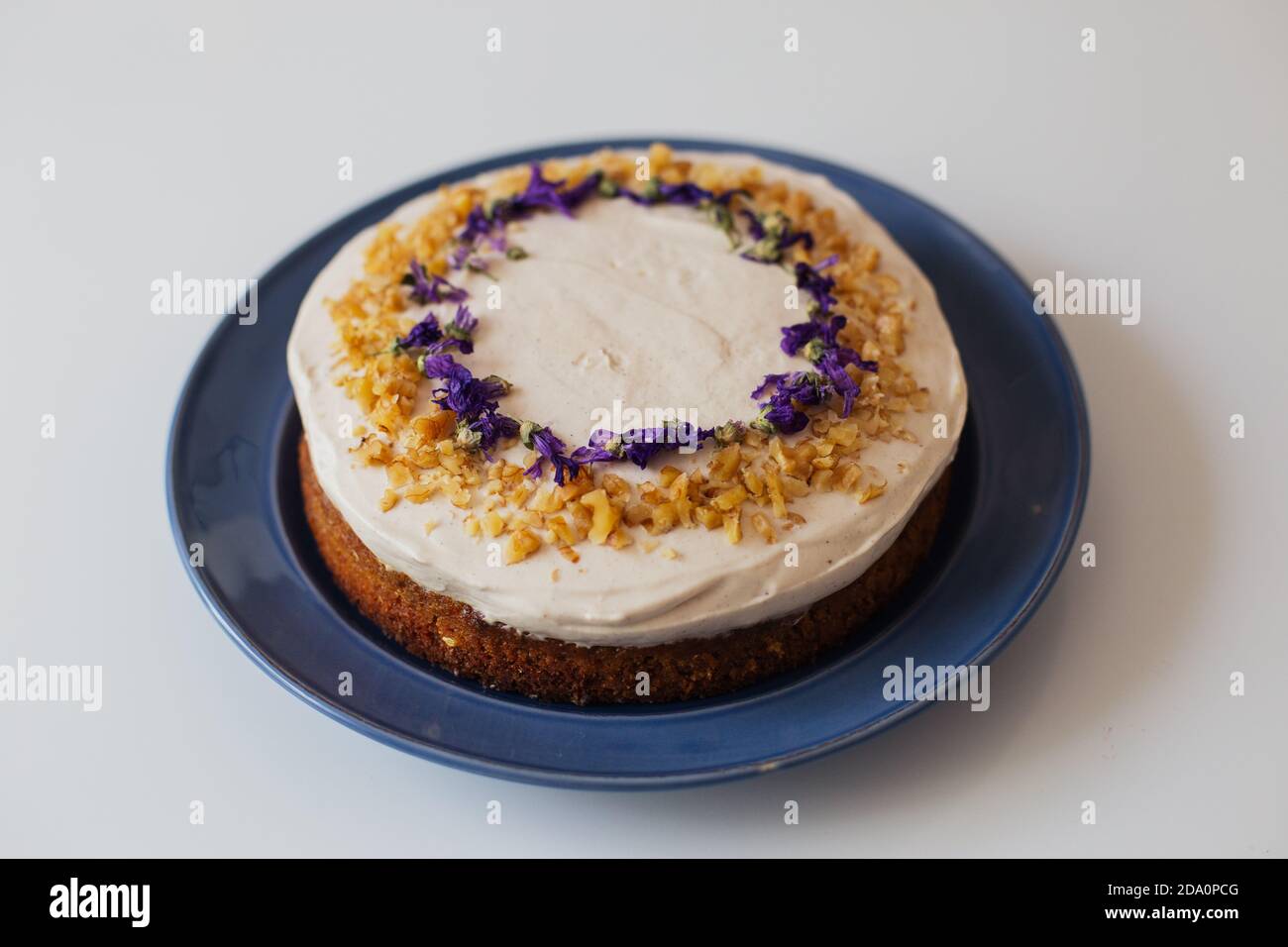 Appetizing rustic homemade cake topped with white cream and decorated ...