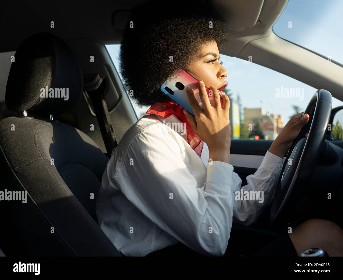 Side view of thoughtful young African American female driving ...