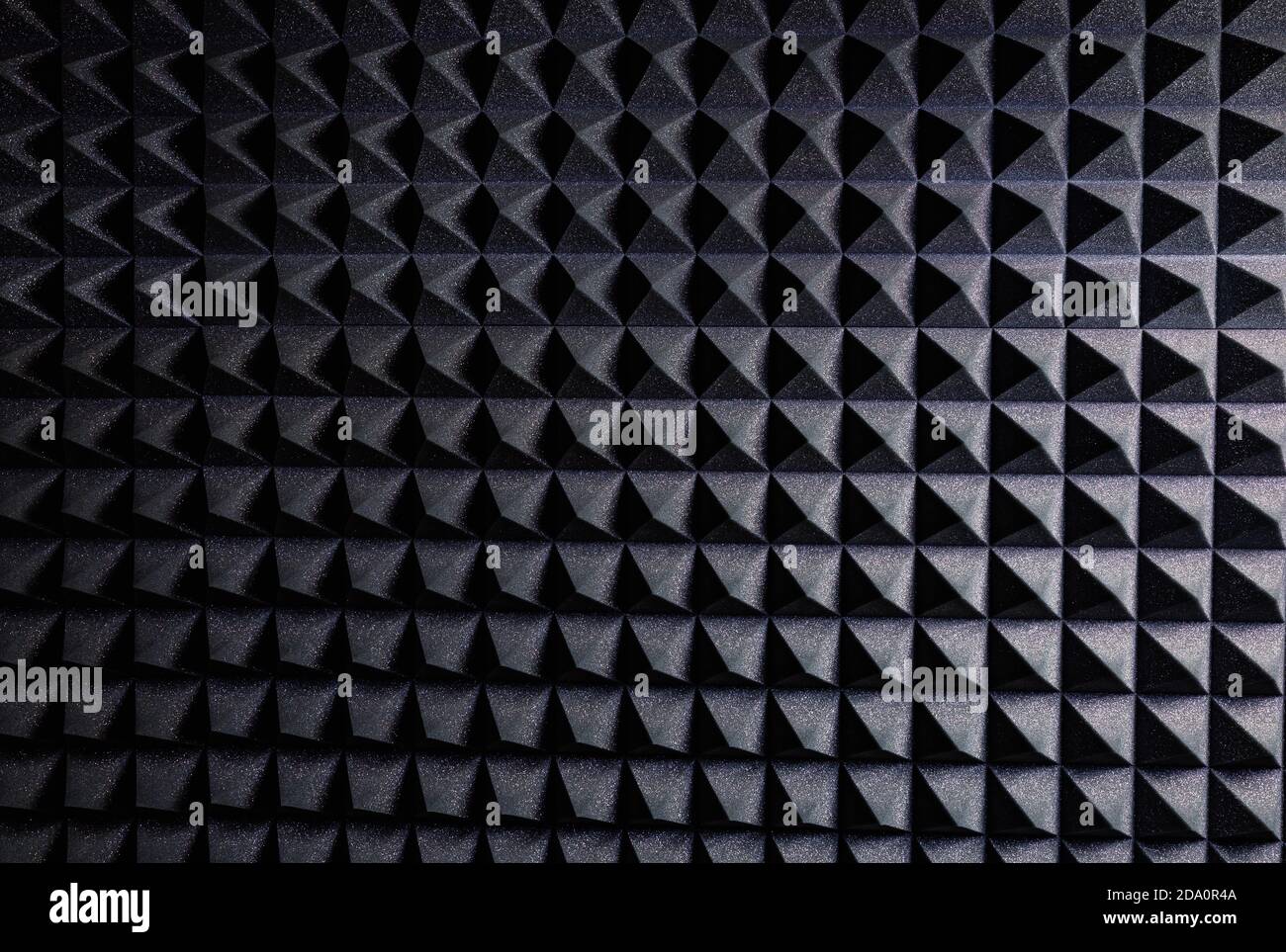 Textured background of wall with black geometric soundproof foam with ...