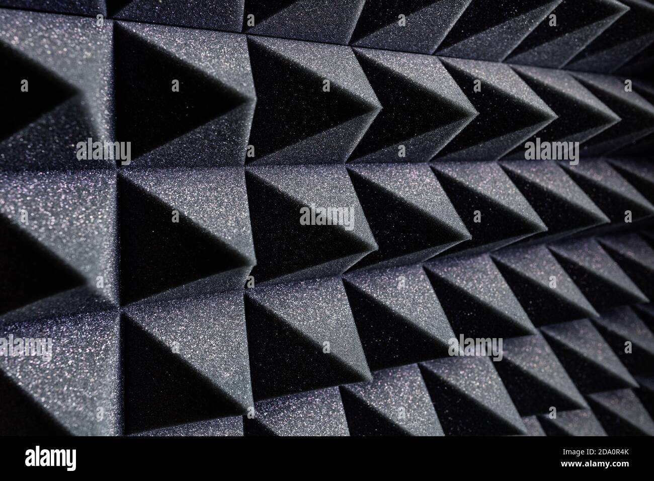 Textured background of wall with black geometric soundproof foam with ...