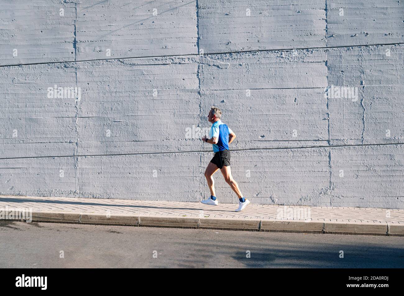 Man running down street hi-res stock photography and images - Alamy