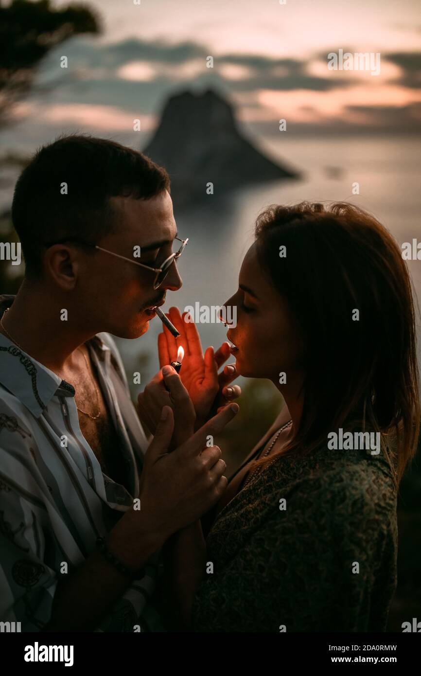 Couple Lighting A Cigarette