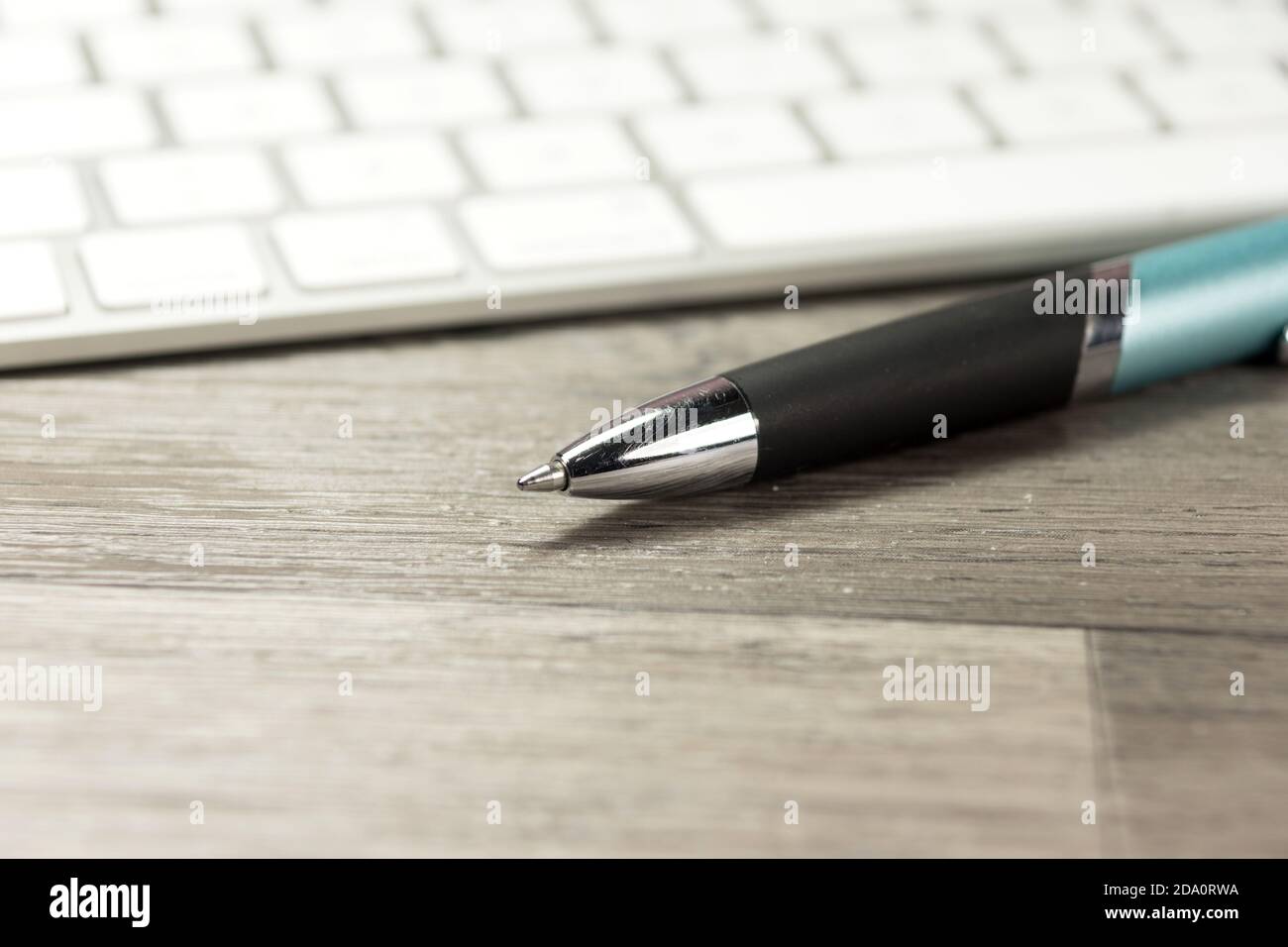 A computer and pen Stock Photo - Alamy