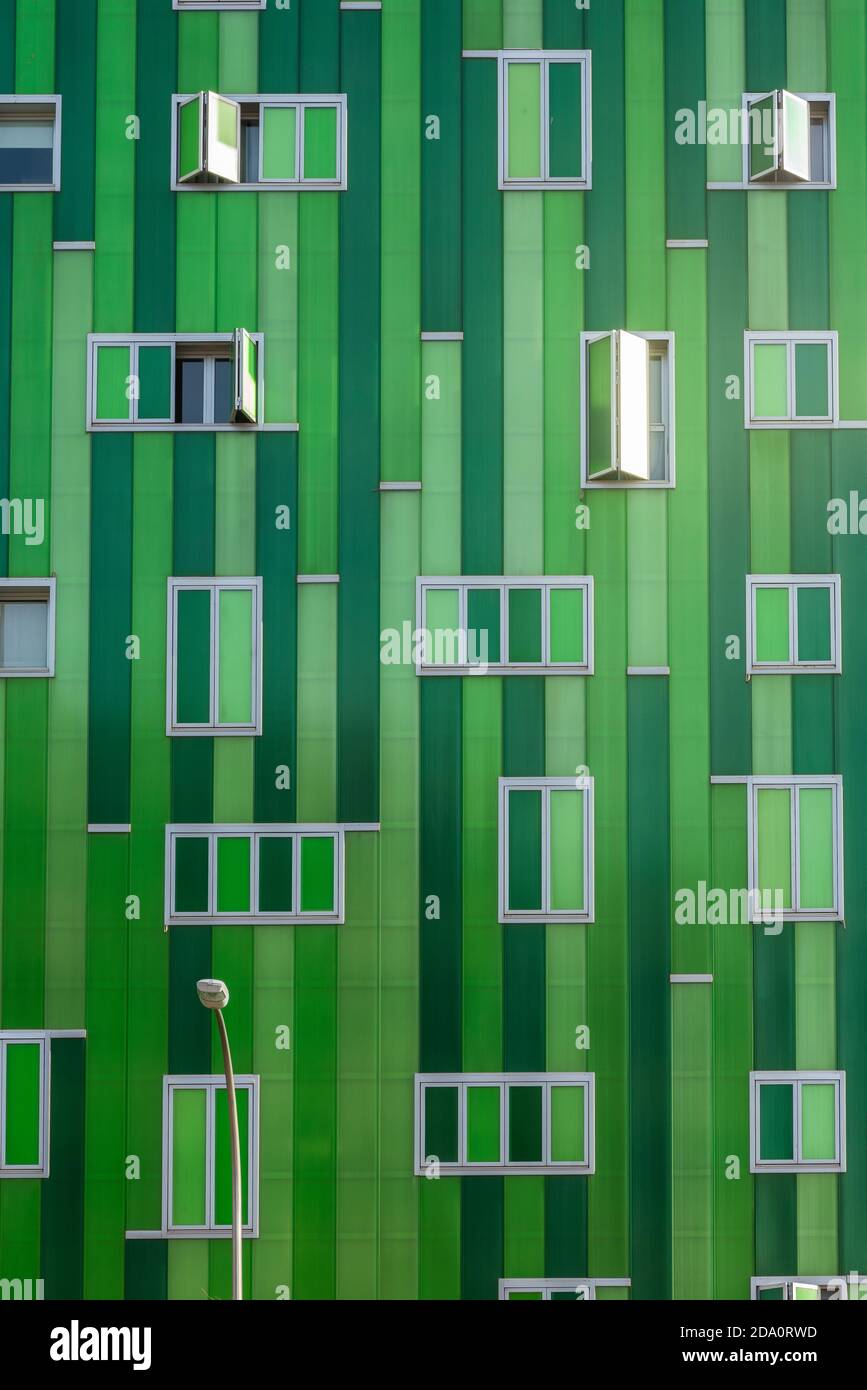 Contemporary building with vivid green facade and opened windows Stock ...
