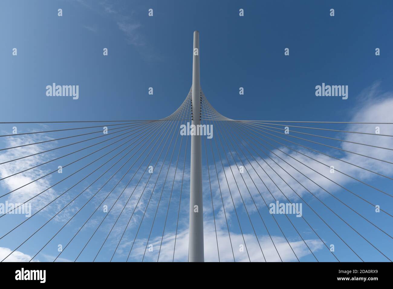 From below of white contemporary suspension bridge with high column ...