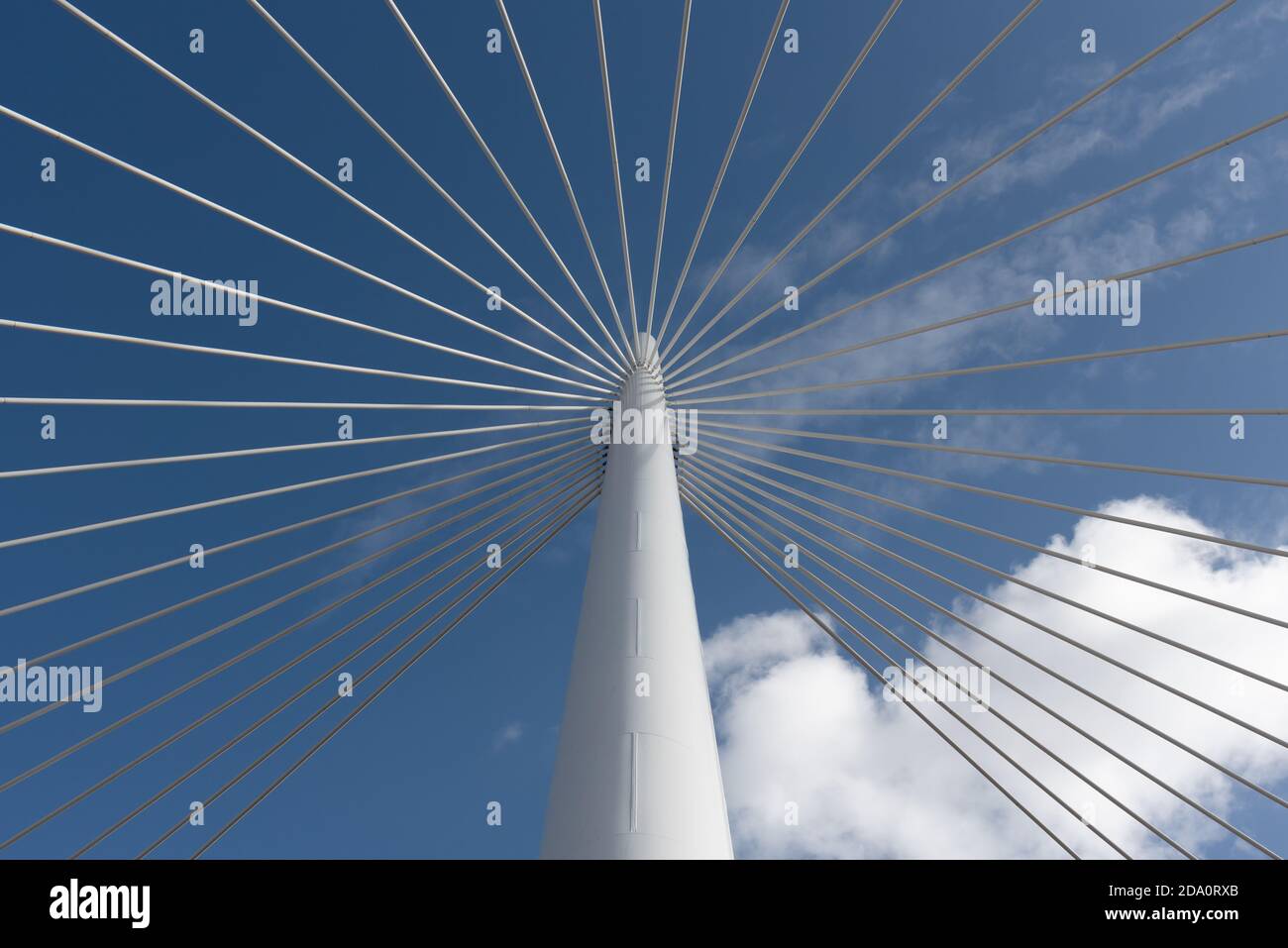 From below of white contemporary suspension bridge with high column ...