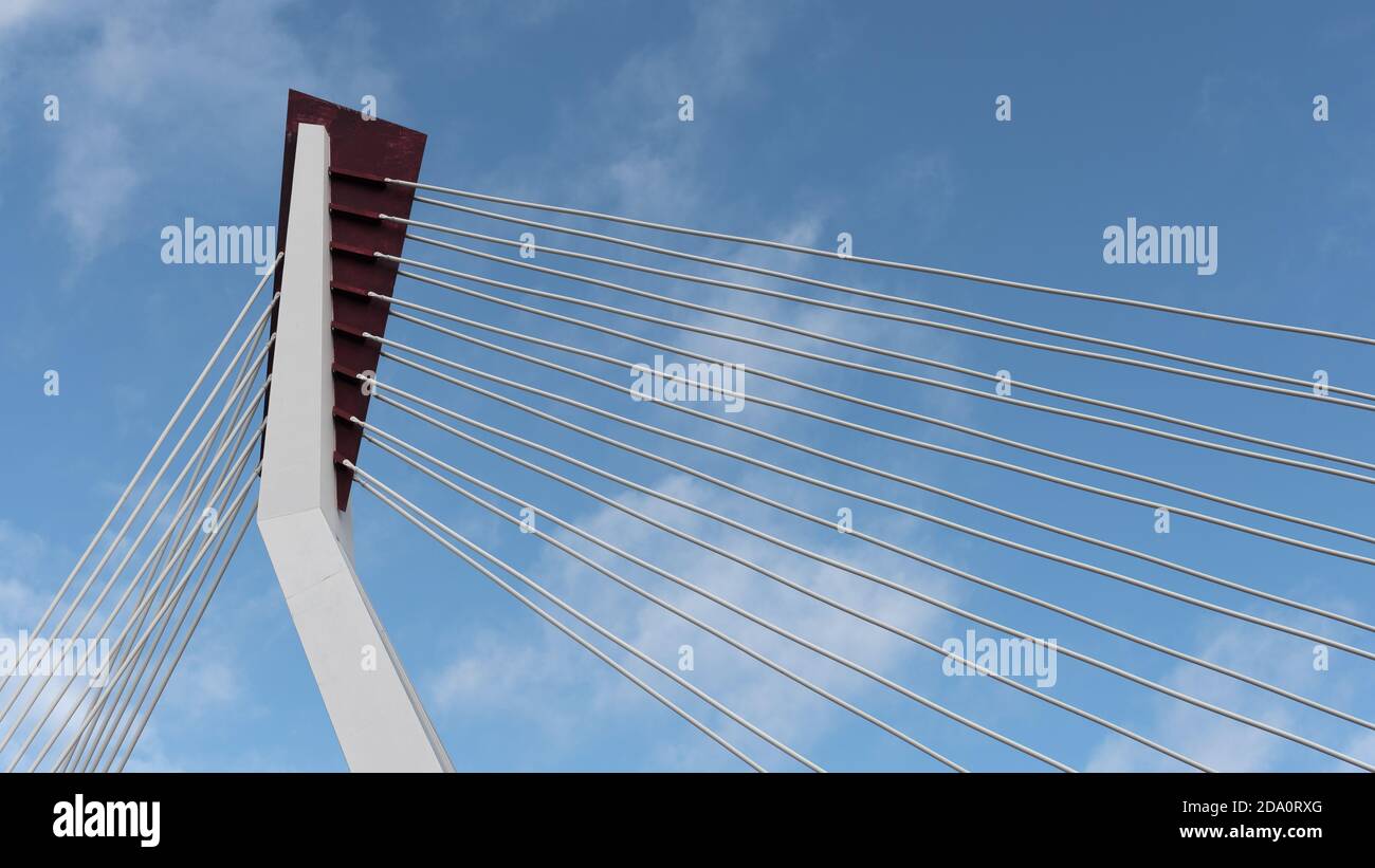 From below of white contemporary suspension bridge with high column ...