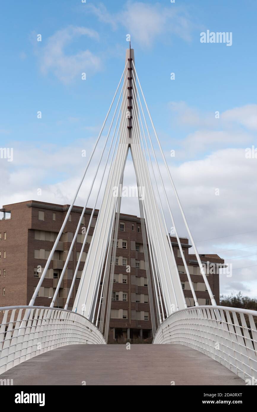 Contemporary suspension footbridge with long steel cables on background ...