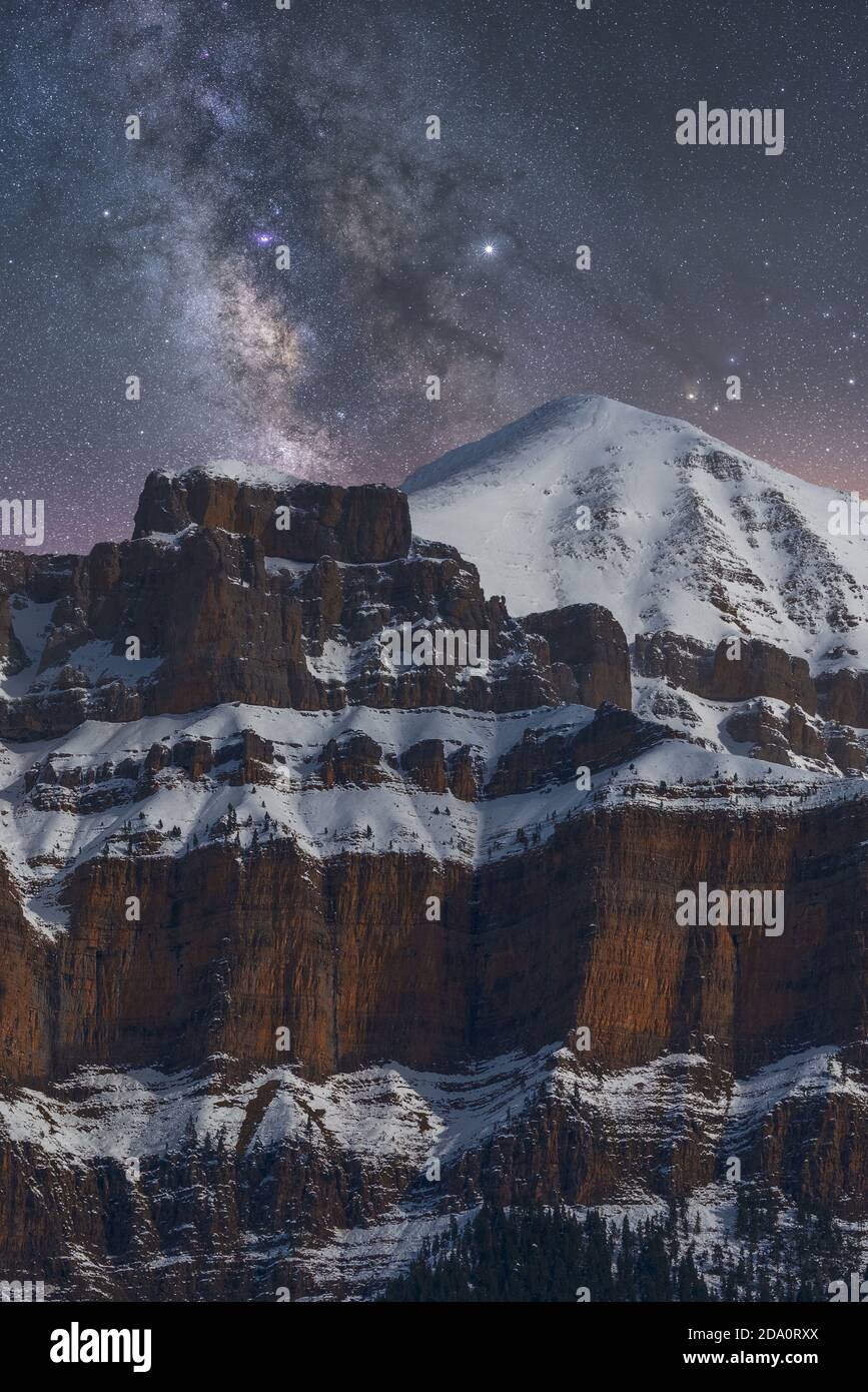 Spectacular view of high rough ridge covered with snow under colorful ...