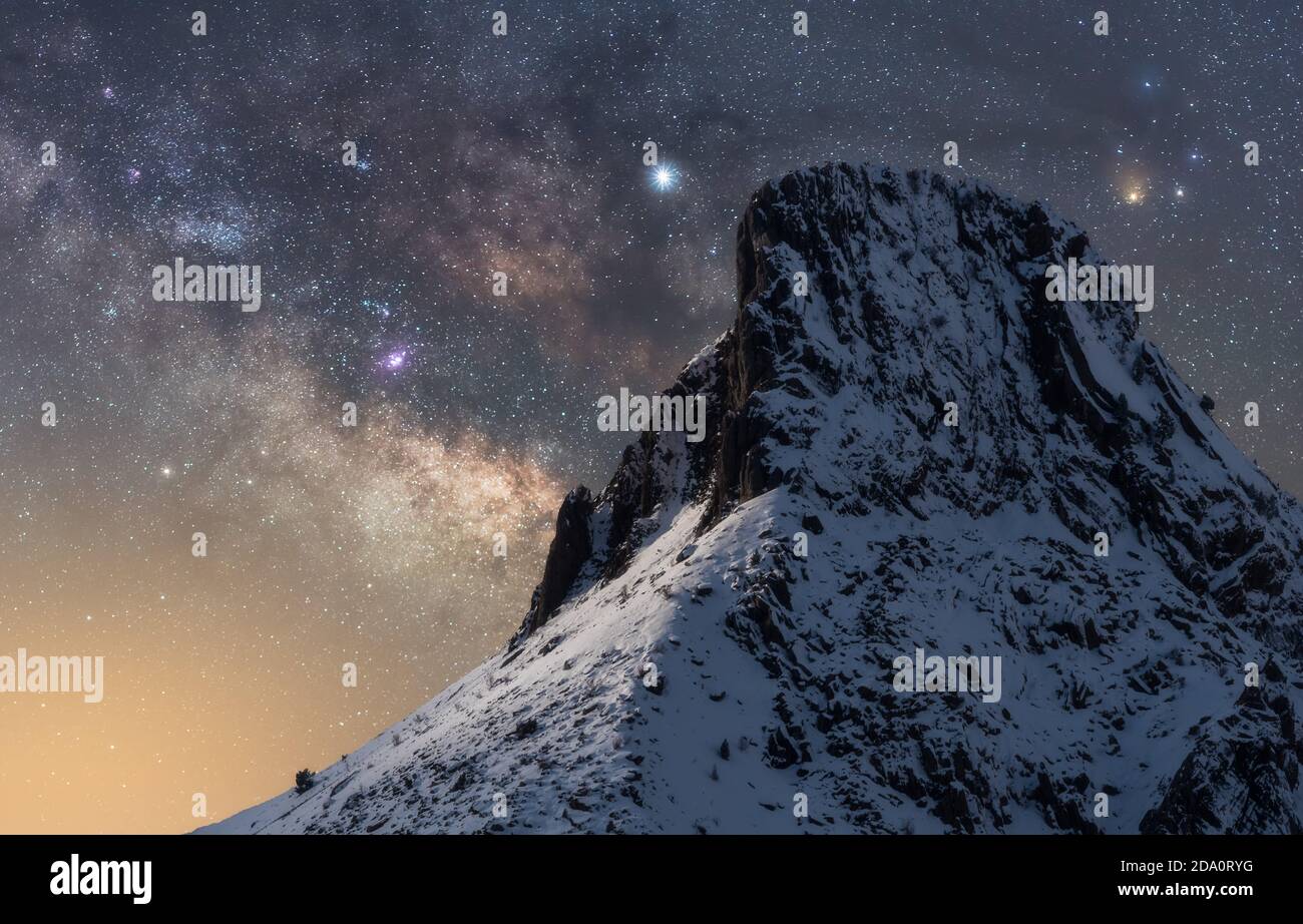 Spectacular view of high rough ridge covered with snow under colorful ...