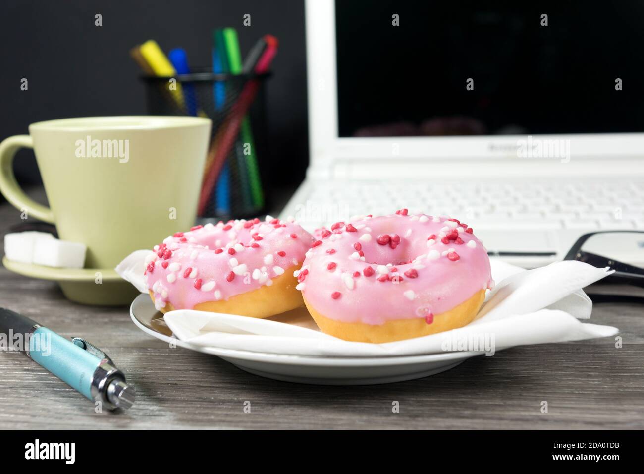 Coffee and donuts on an office table Stock Photo - Alamy