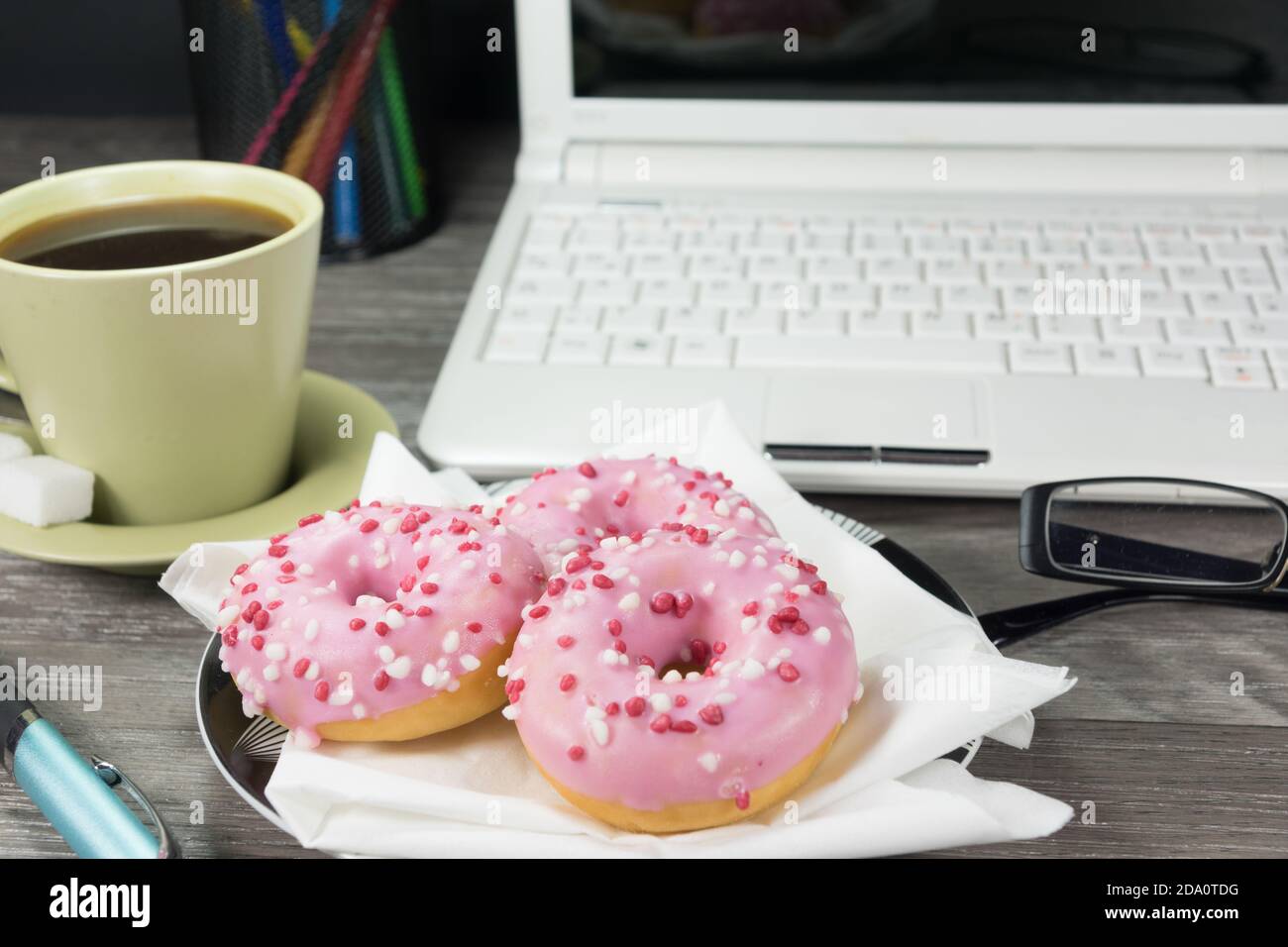 Coffee and donuts on an office table Stock Photo - Alamy