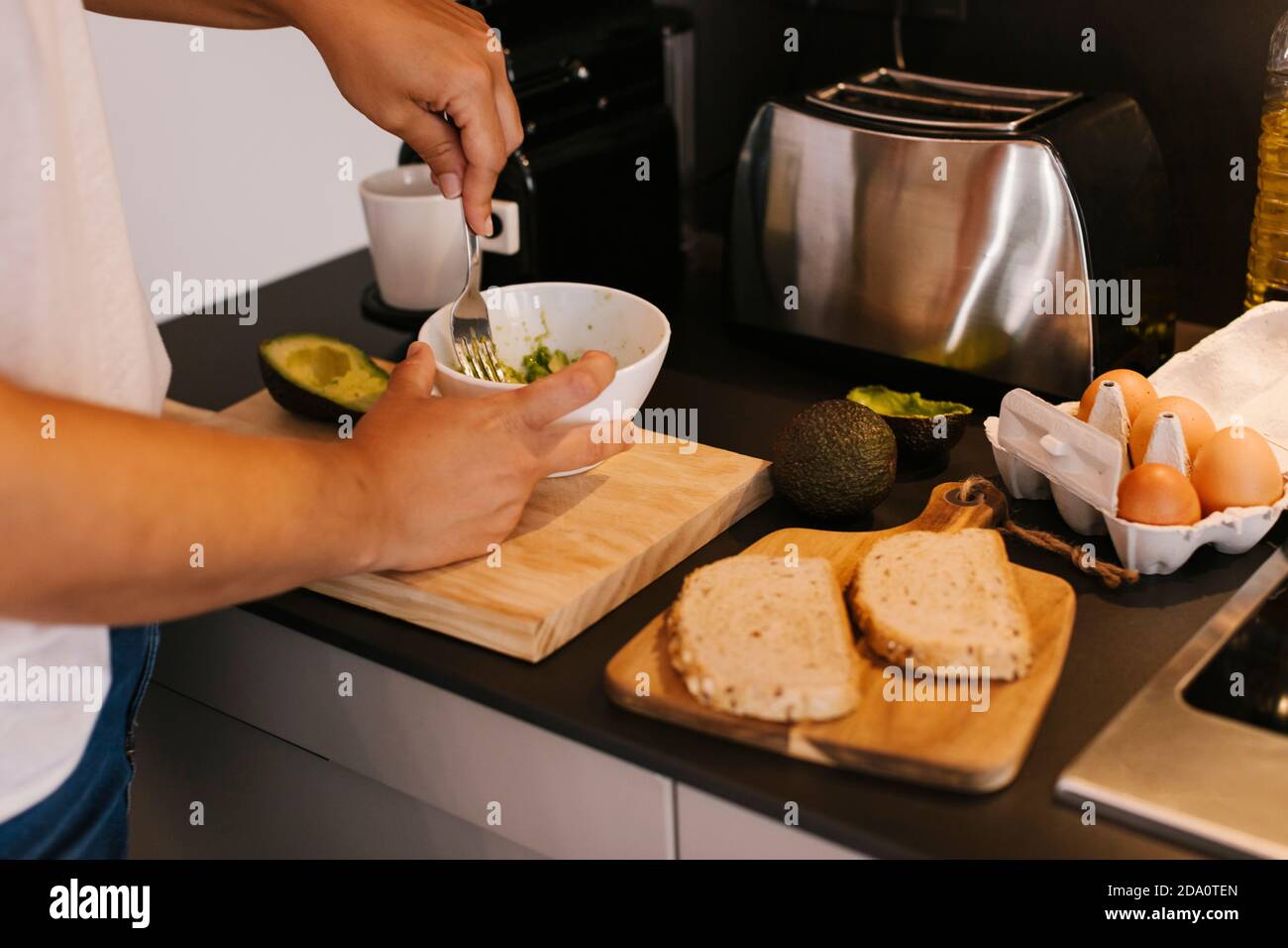 Concentrated Woman preparing breakfast Stock Photo - Alamy