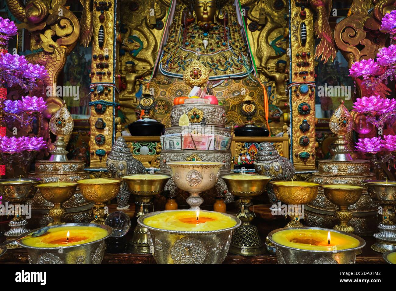 Golden decorative elements in Buddhist shrine with burning flames in ...