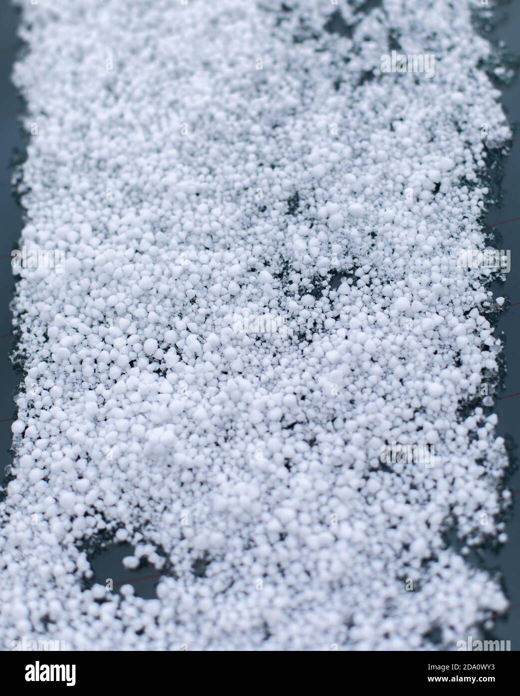 Round white snow balls, snow crumb texture background, small hail on ...