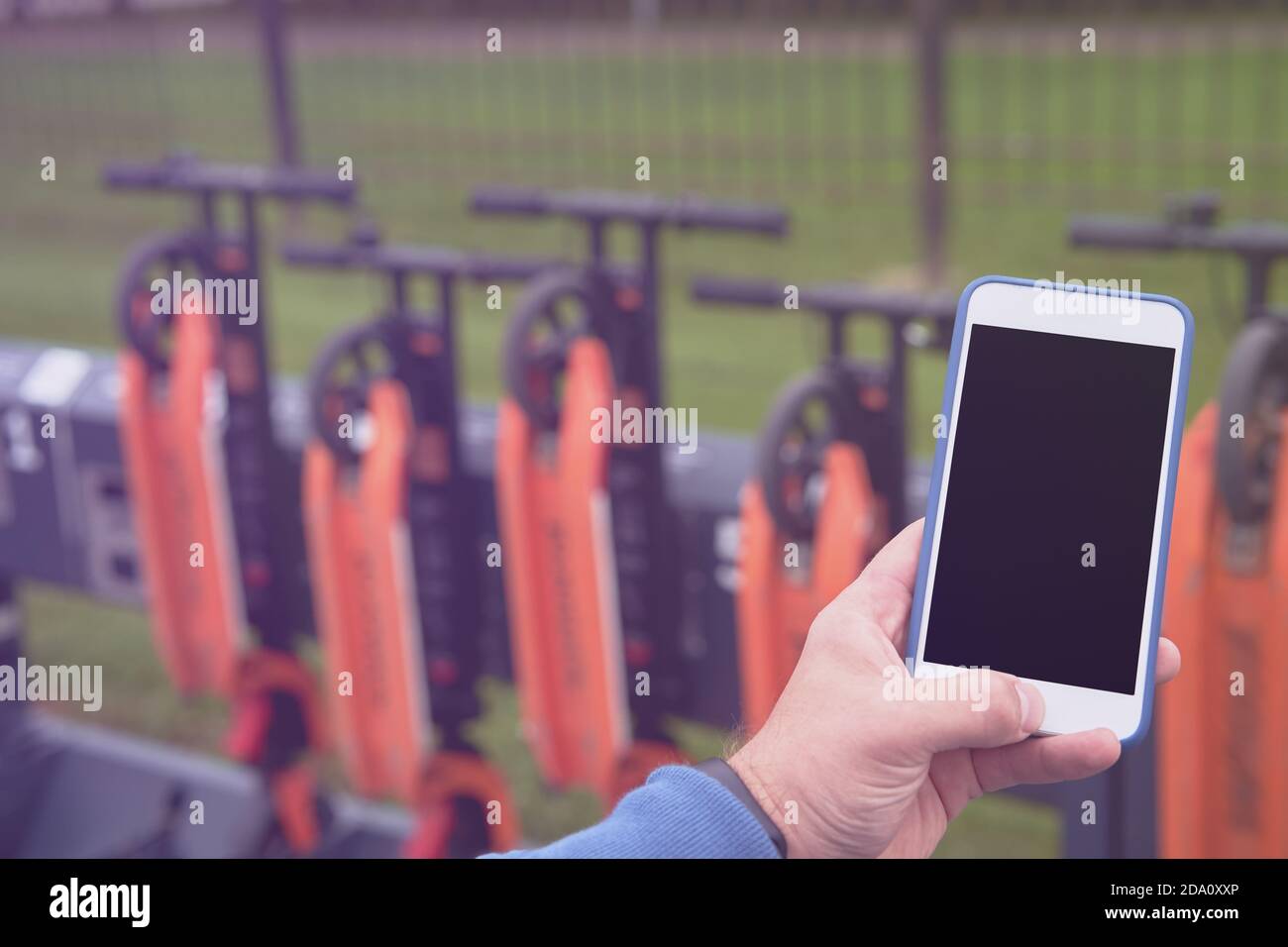 Renting electric scooter by scanning QR code by smartphone outside ...