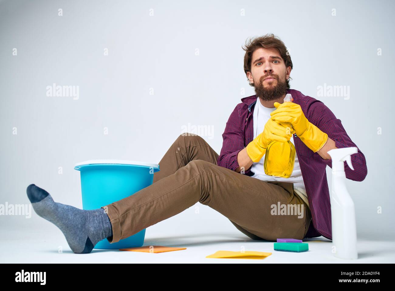 cleaner lying on the floor with a bucket of detergent cleaning service ...