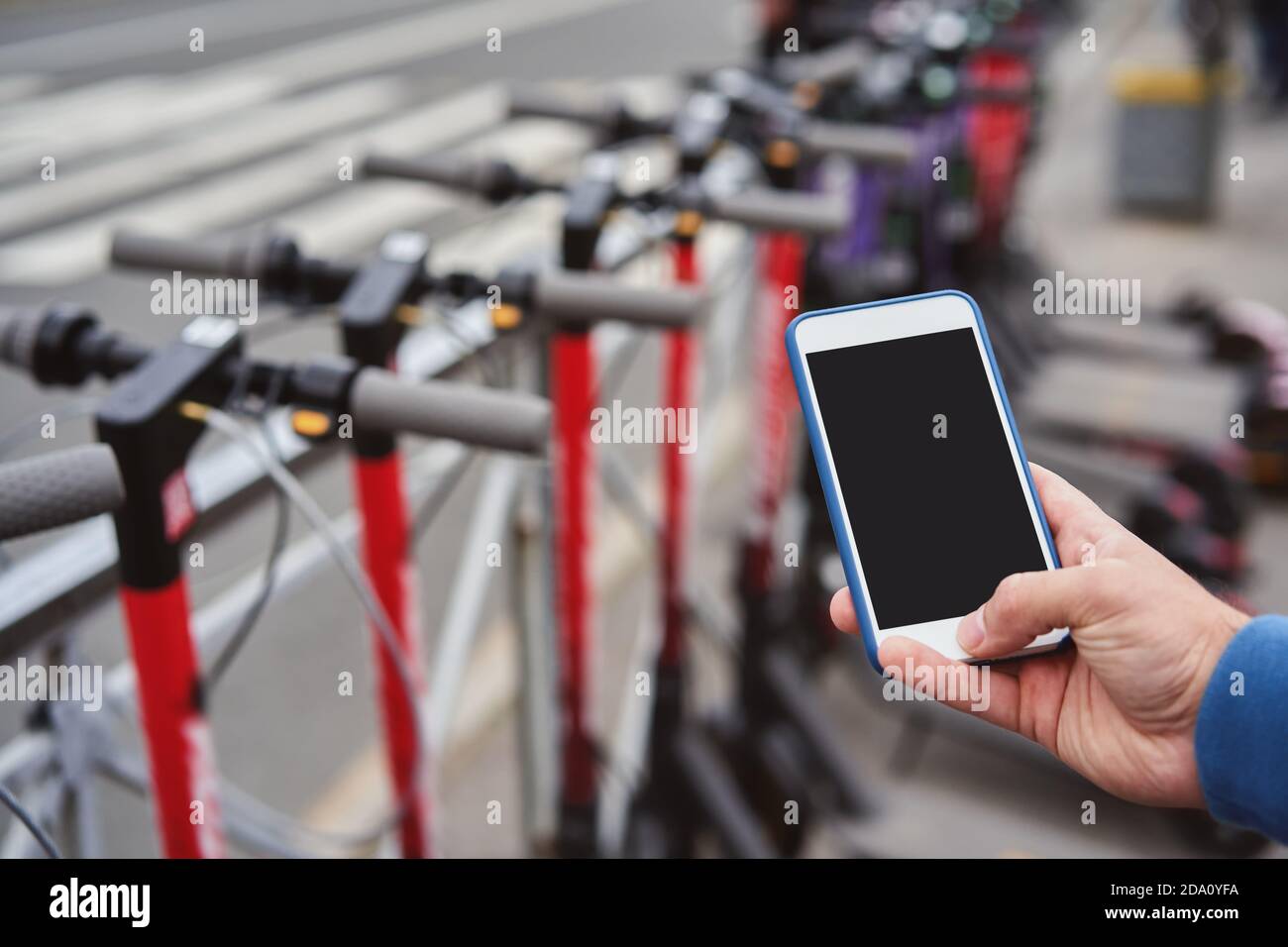 Renting electric scooter by scanning QR code by phone outdoor Stock ...