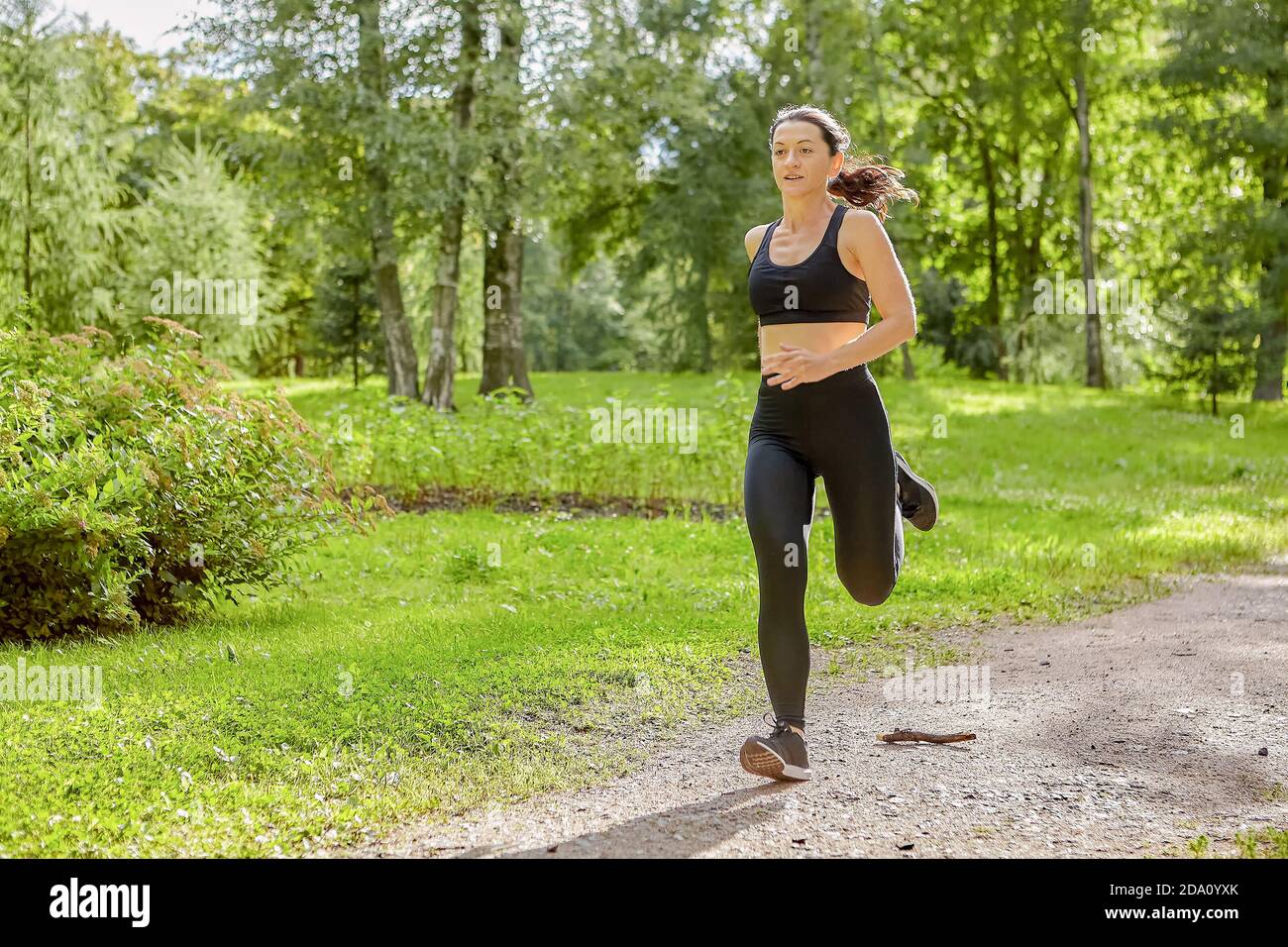 Active white woman is running in park for healthy at daytime Stock ...