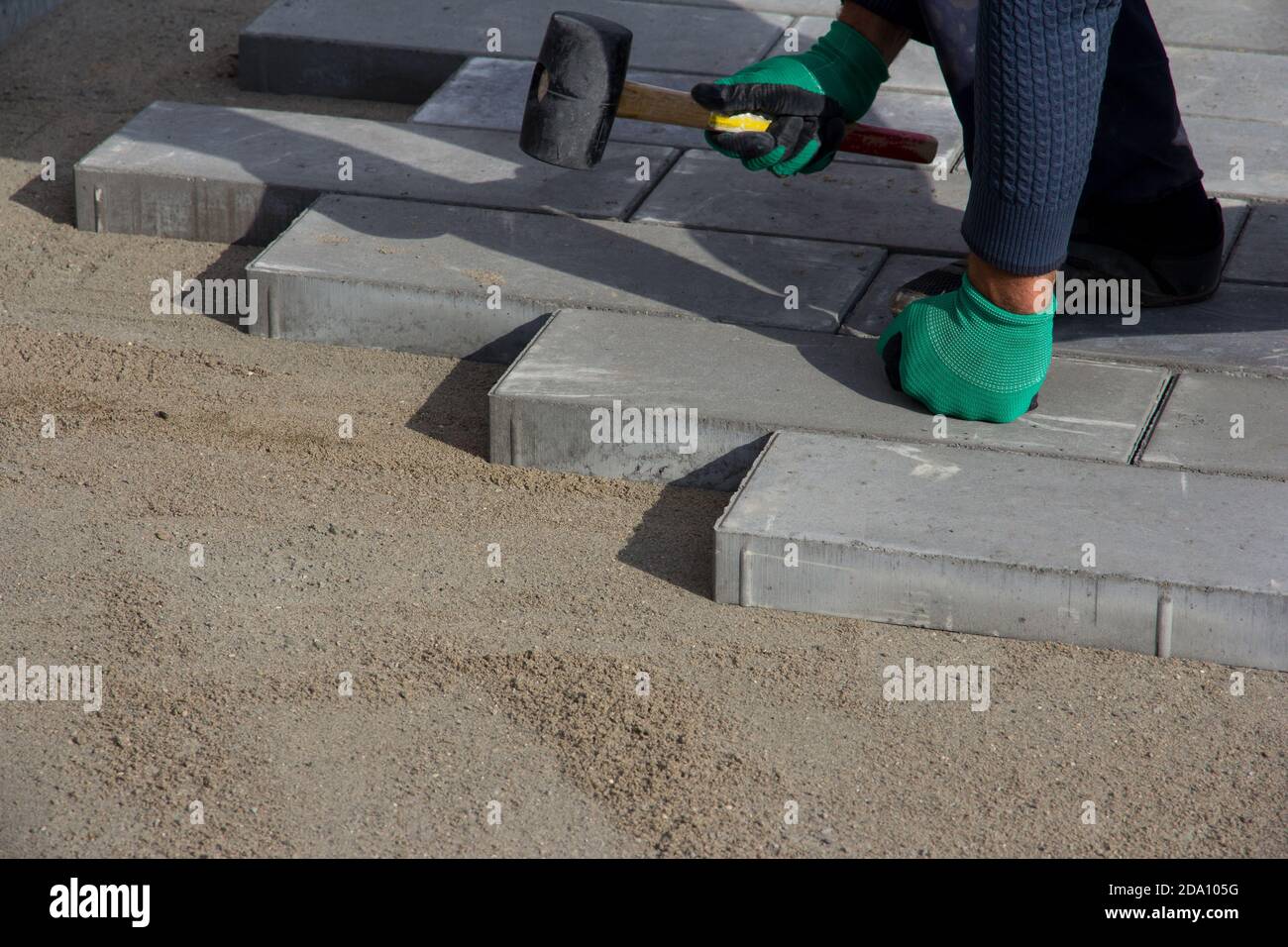 Brick Paver Working. Worker lay paving tiles, construction of brick ...
