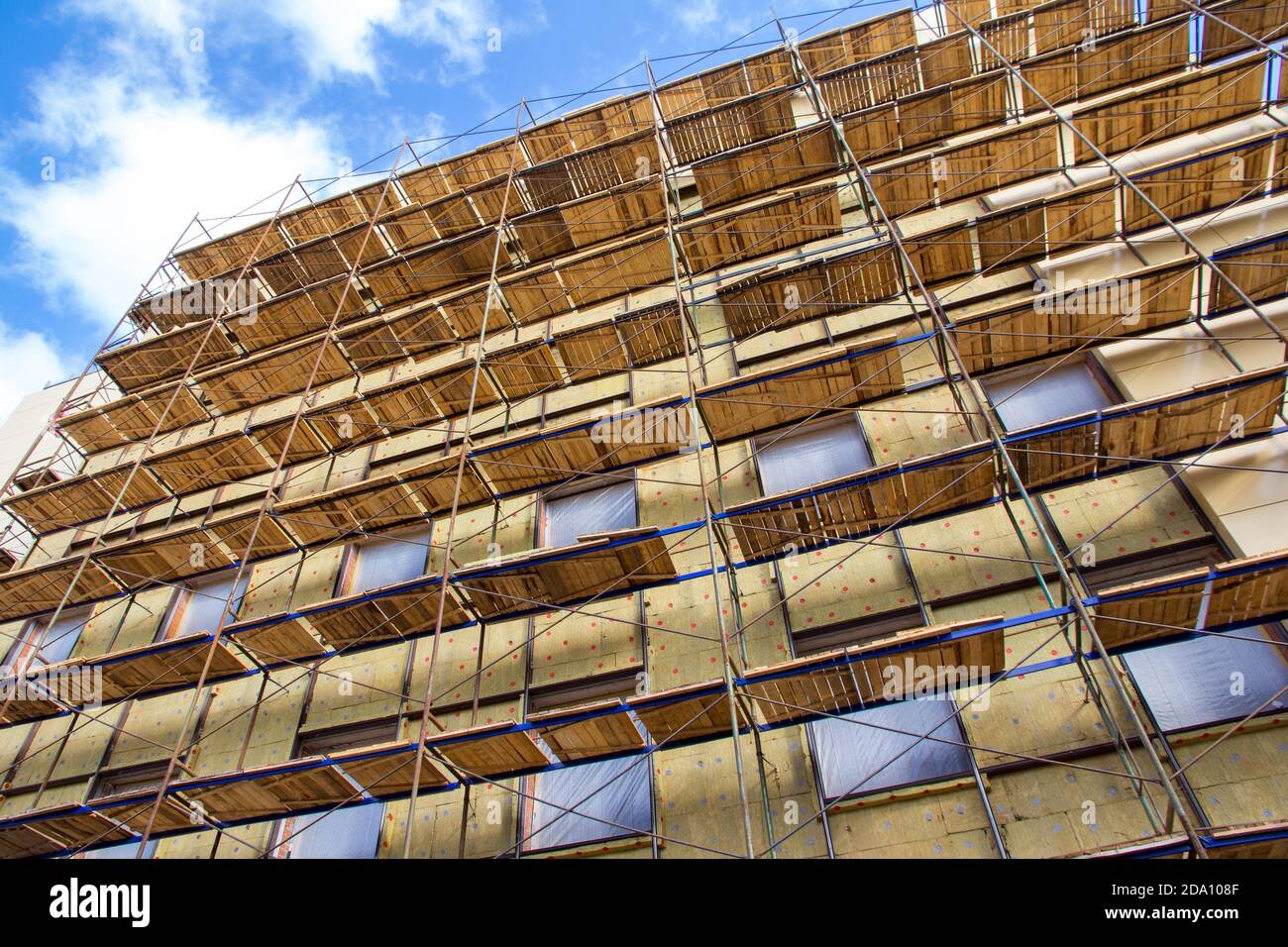 Building construction site with scaffolding. The exterior of the facade ...