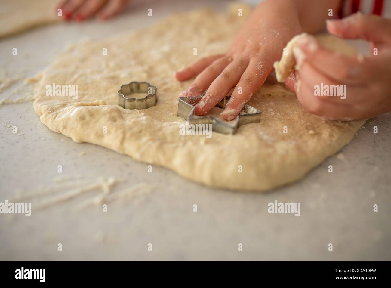 Child using different shapes to cut the dough Stock Photo - Alamy