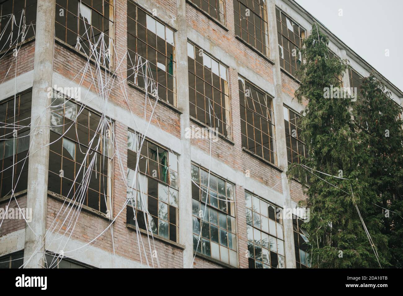 View of broken windows in an old abandoned brick building Stock Photo - Alamy