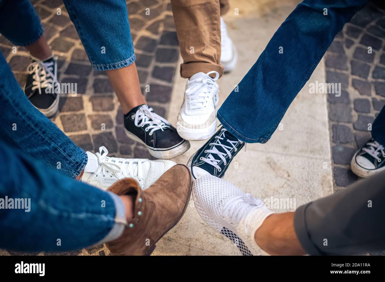 Friends greeting with foots for greeting in the covid-19 time ...