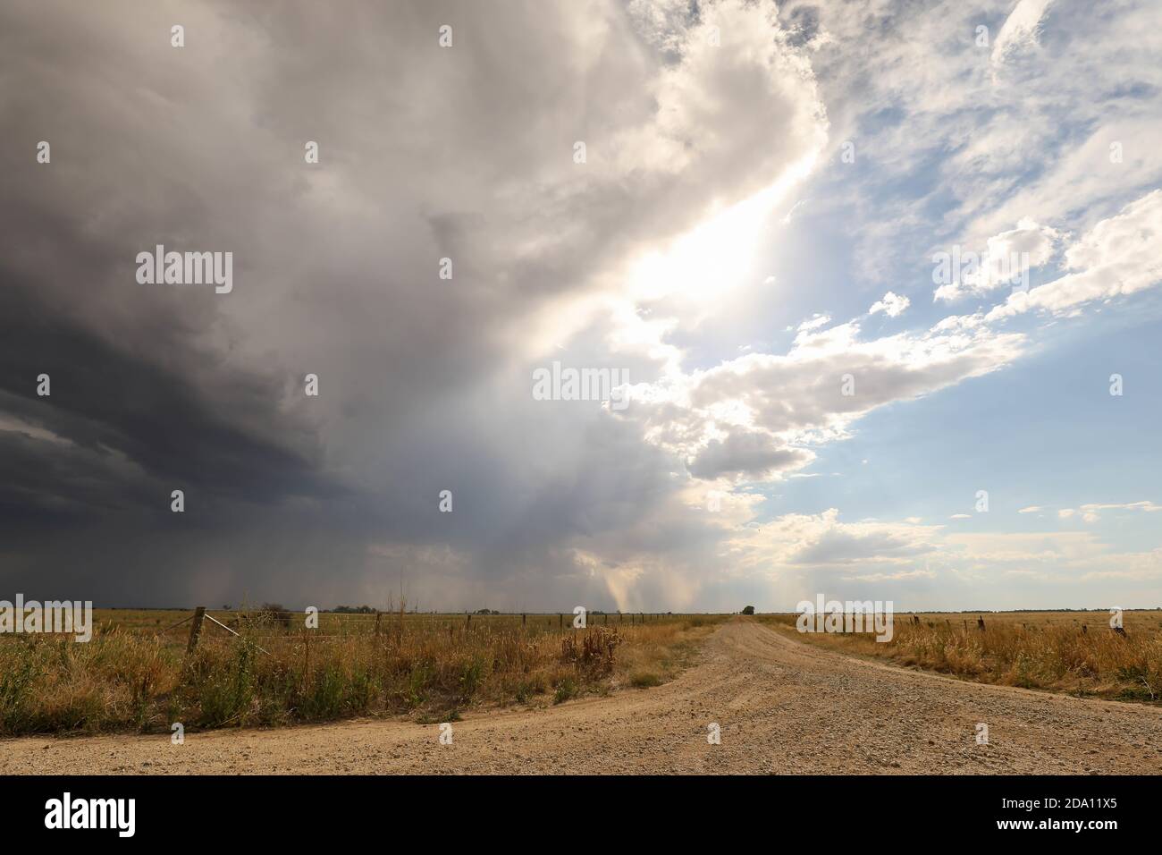 Dry field under cloudy sky Stock Photo - Alamy