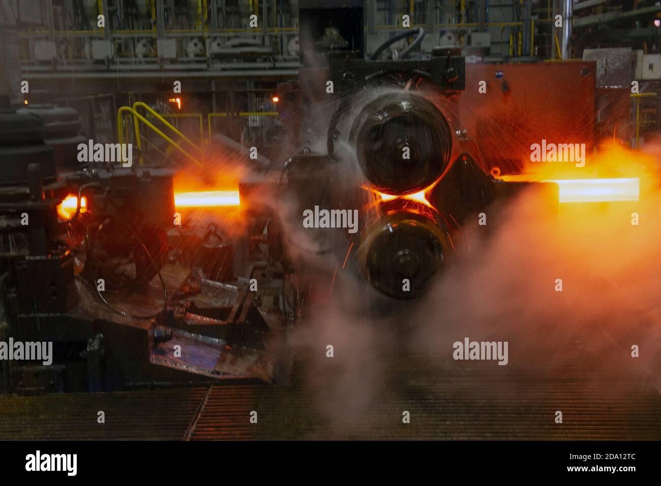 hot steel on conveyor in a steel mill. hot rolled rebar Stock Photo - Alamy