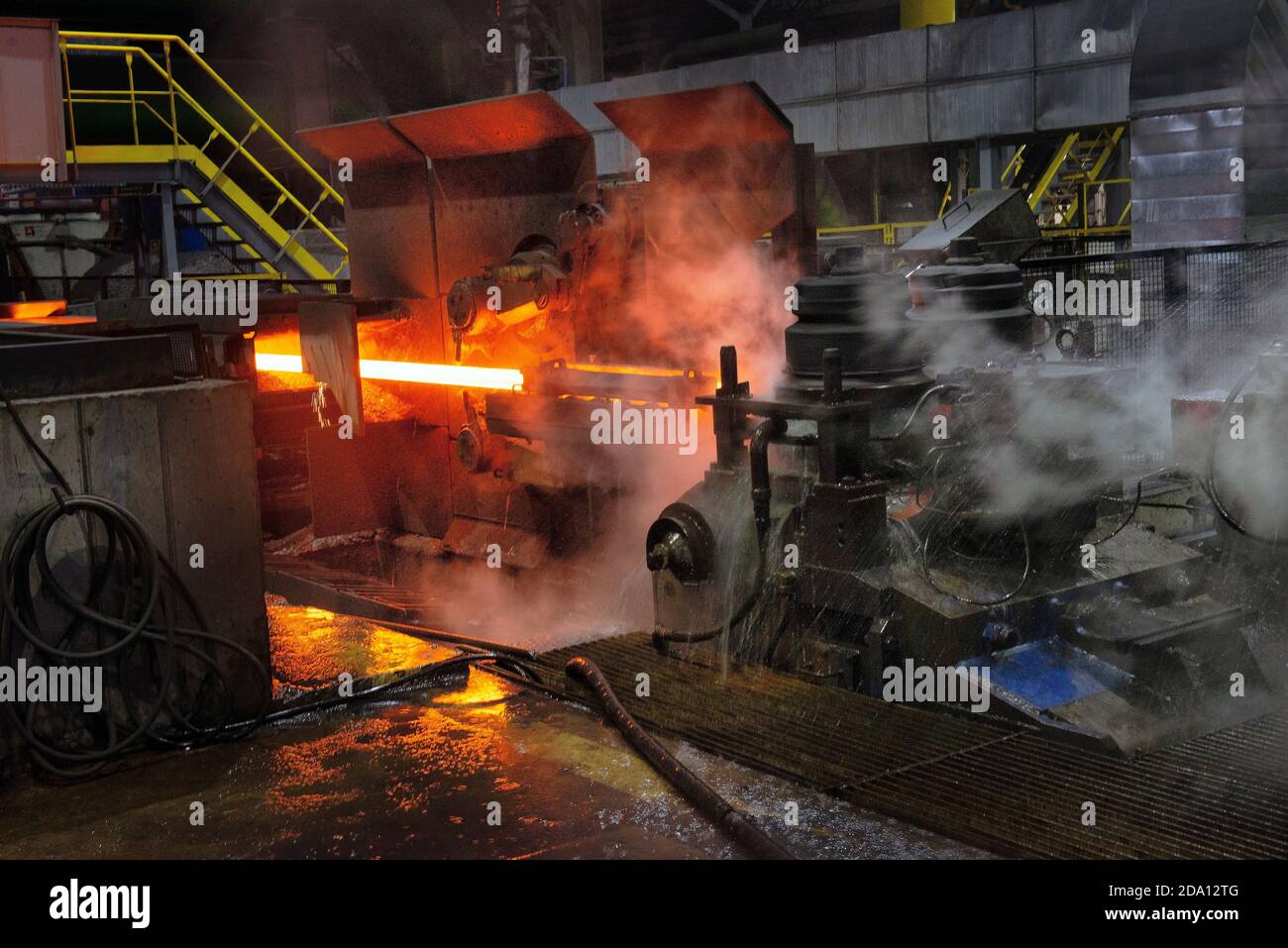 hot steel on conveyor in a steel mill. hot rolled rebar Stock Photo - Alamy