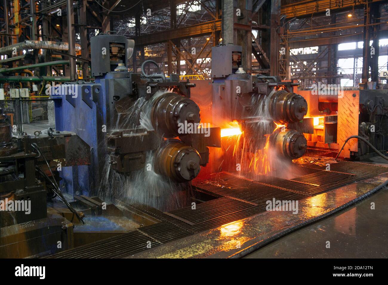 hot steel on conveyor in a steel mill. hot rolled rebar Stock Photo - Alamy