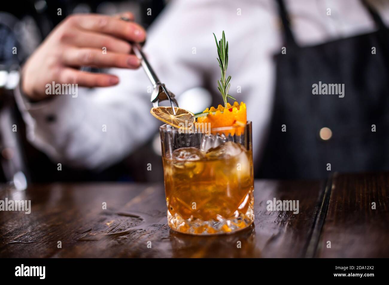 Charming girl bartender makes a cocktail at the nightclub Stock Photo ...