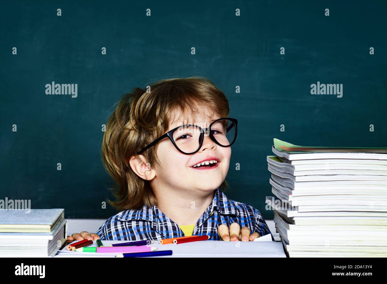 Happy mood smiling broadly in school. School kids against green ...