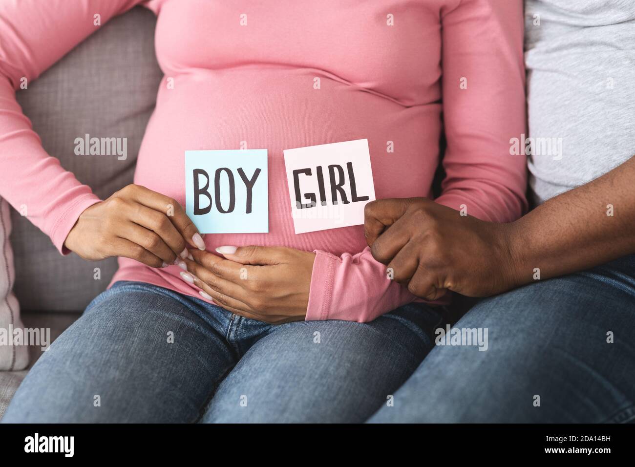Expecting couple holding color cards for baby boy or girl Stock Photo ...
