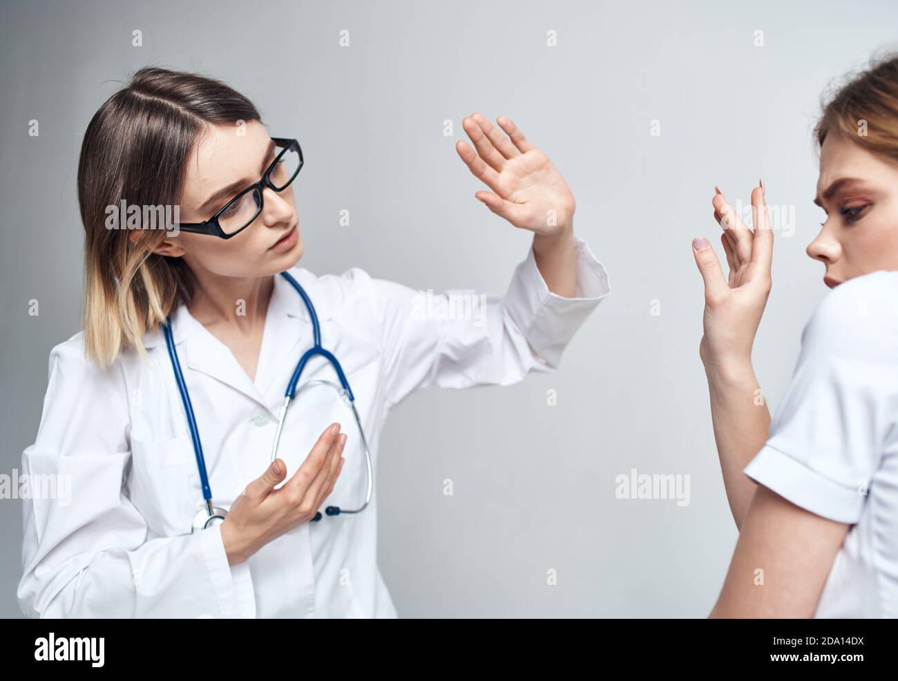 Nurse and patient gestures with hands light background stethoscope ...