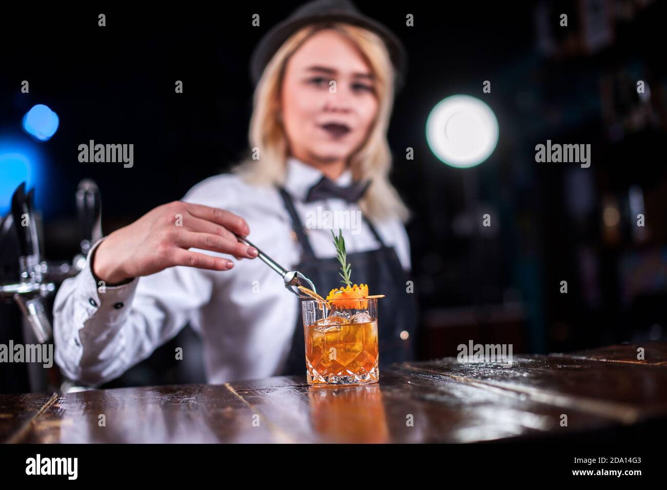 Confident woman bartending demonstrates his professional skills in the ...