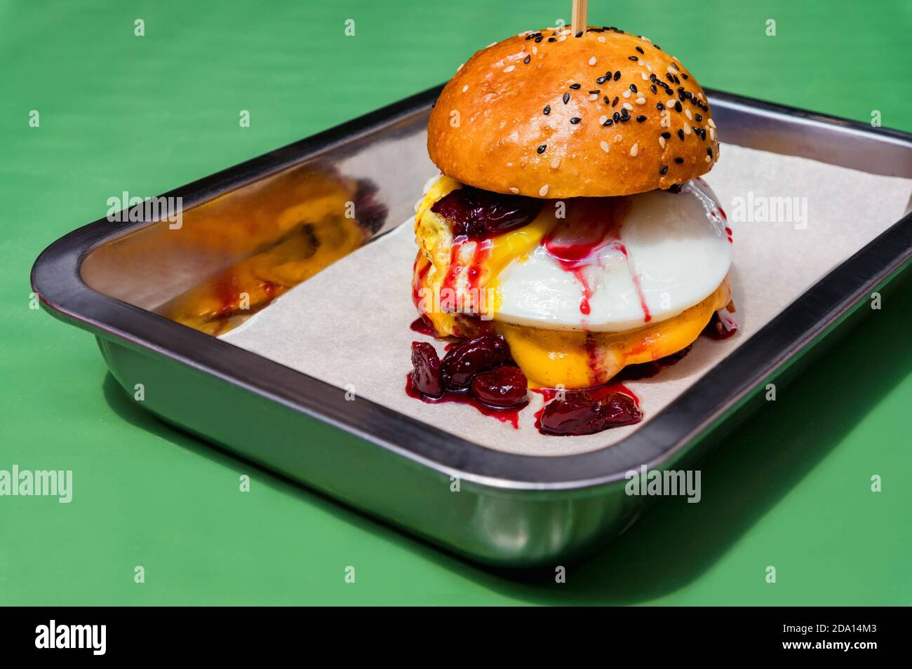 Close up tasty burger with different filling served on tray Stock Photo ...