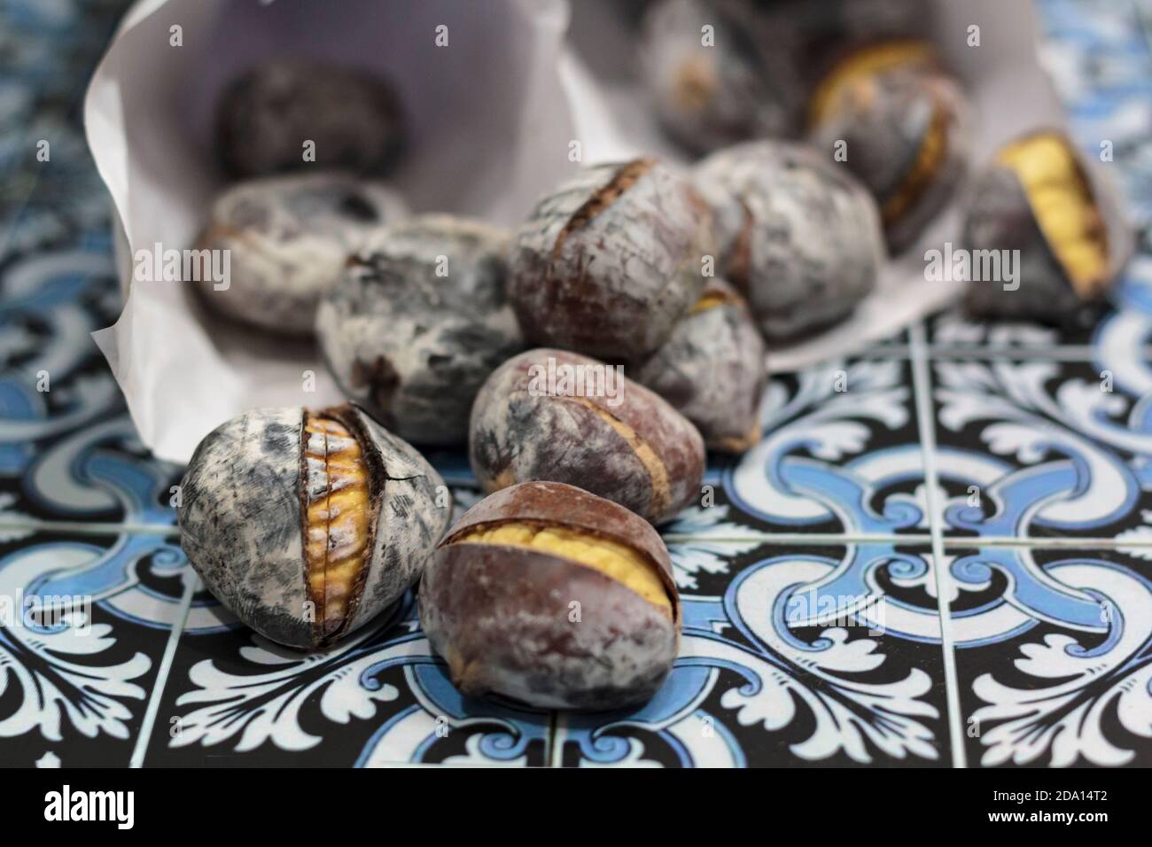 Roasted chestnuts on Portuguese tiles background Stock Photo - Alamy