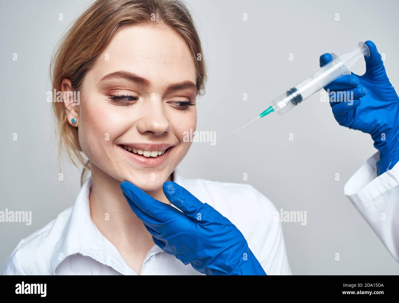 Scared woman and syringe in the hands of the doctor shock emotions ...