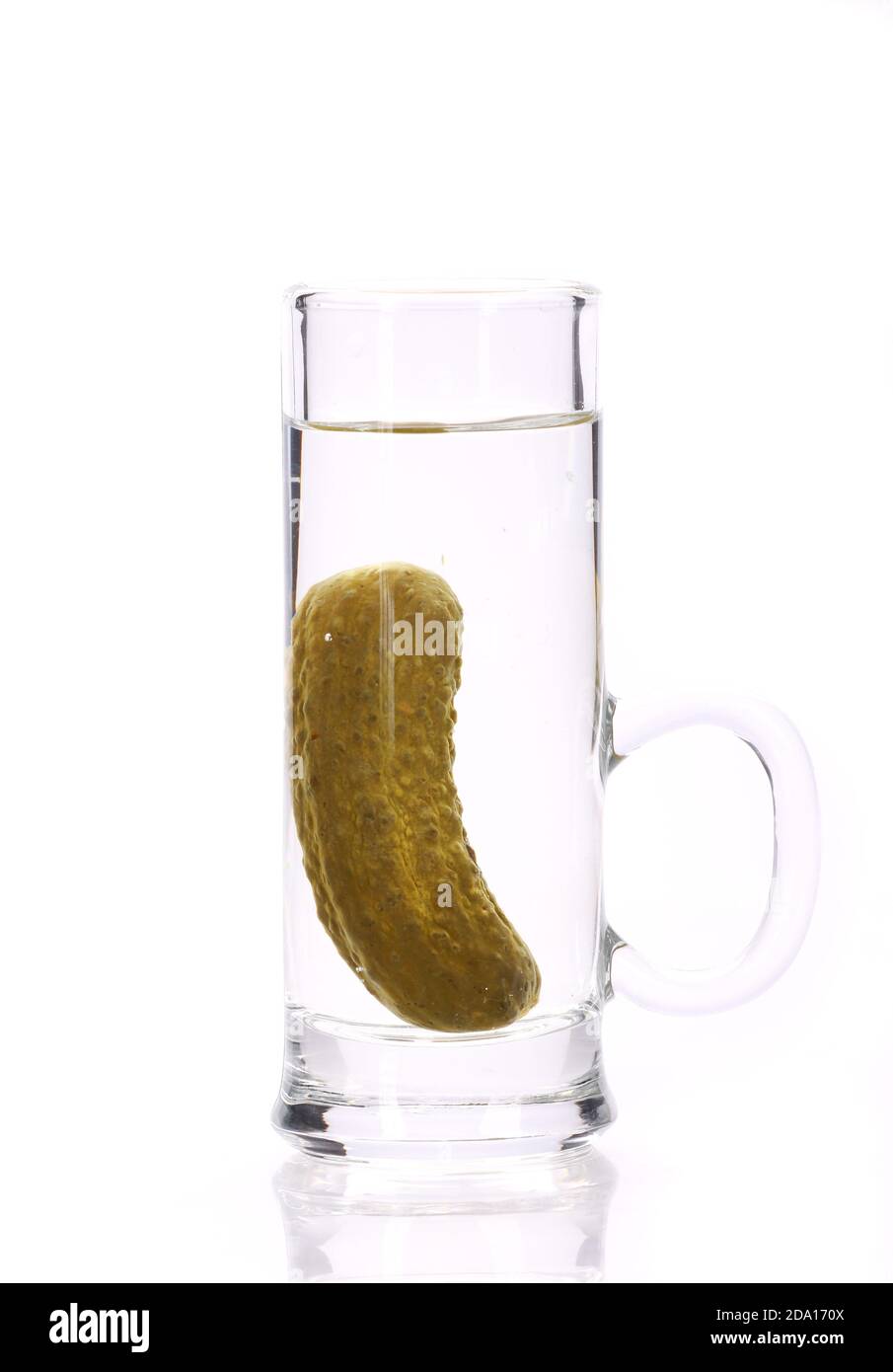 Pickle in a glass filled with water on a white background Stock Photo ...